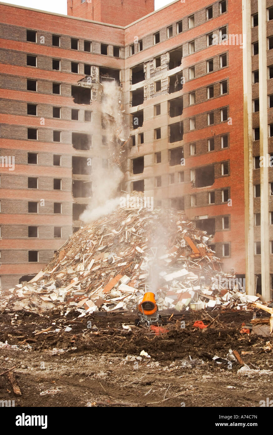 A huge pile of debris from the demolition of a brick high-rise building ...
