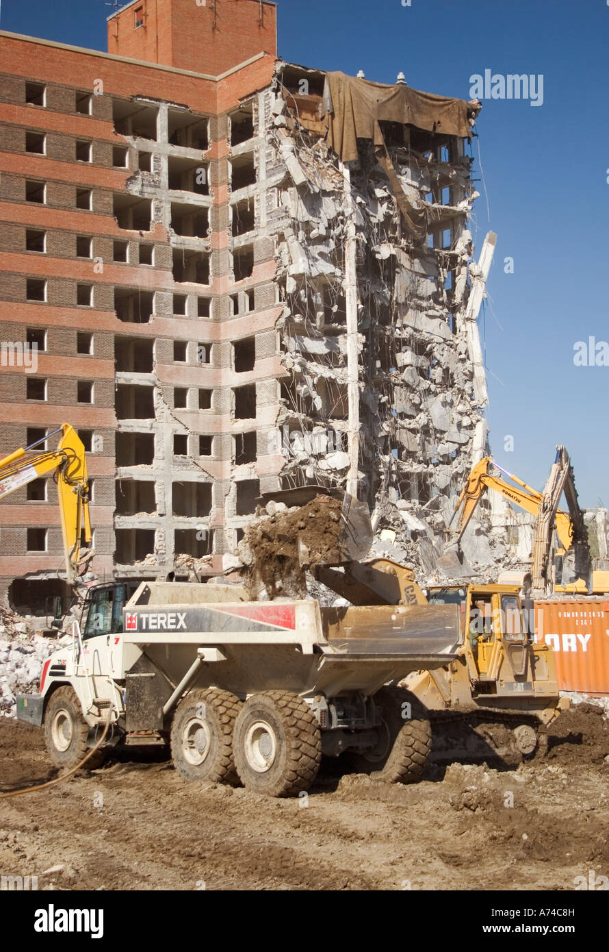 Demolition of an inner city brick high-rise building. Hauling debris to ...