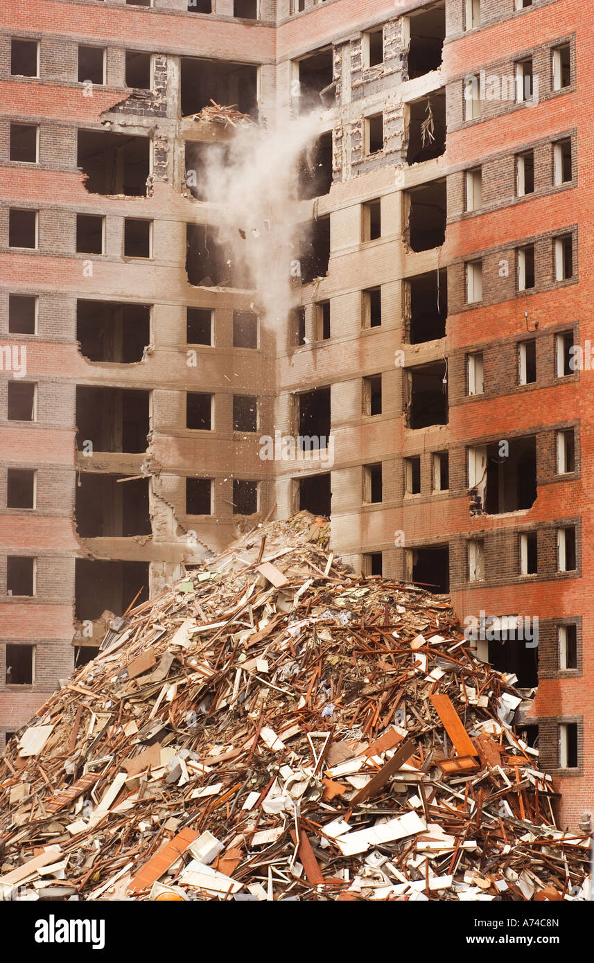 A huge pile of debris from the demolition of a brick high-rise building ...