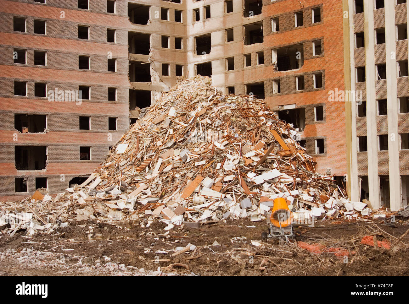 A huge pile of debris from the demolition of a brick high-rise building ...