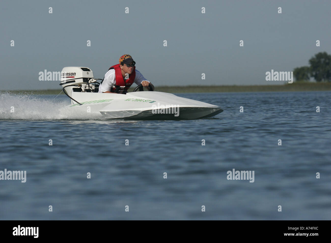 Young man driving a hydroplane boat Stock Photo - Alamy