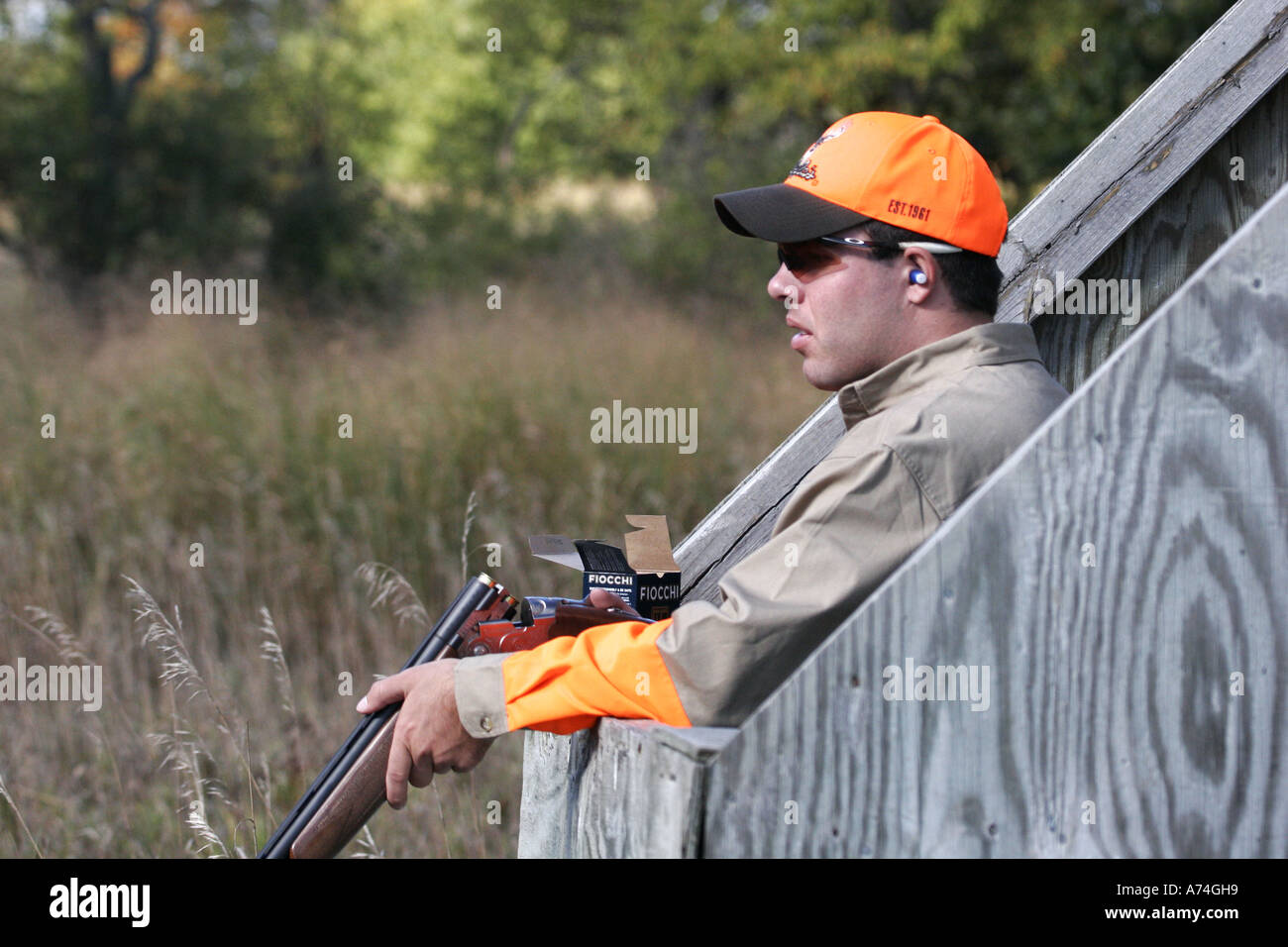 A hunter waiting in a stand for incoming birds during a driven hunt ...
