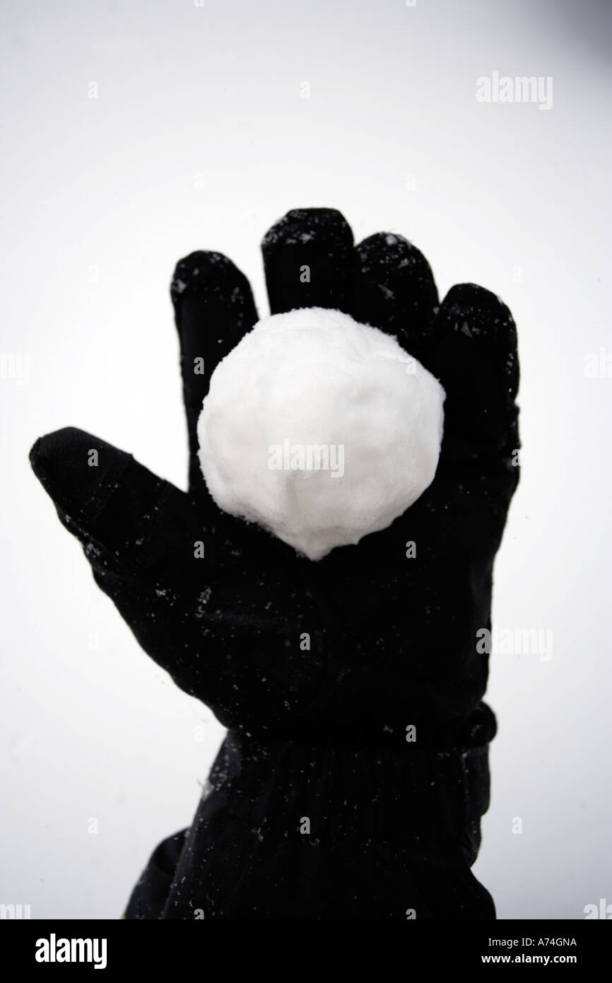 Gloved hand holding snowball, snowball in hand Stock Photo - Alamy