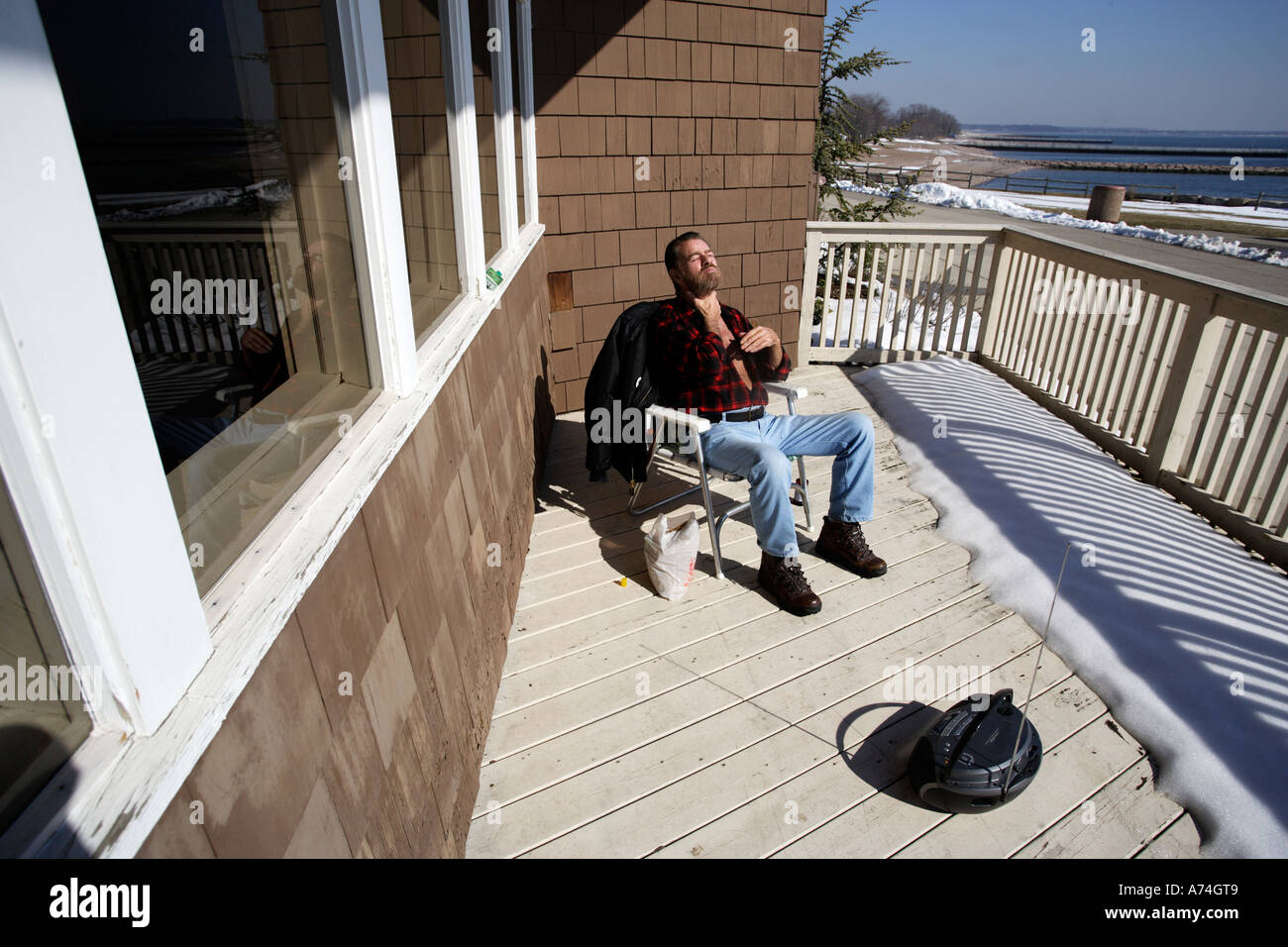 Man sunbathing in winter with snow Stock Photo - Alamy