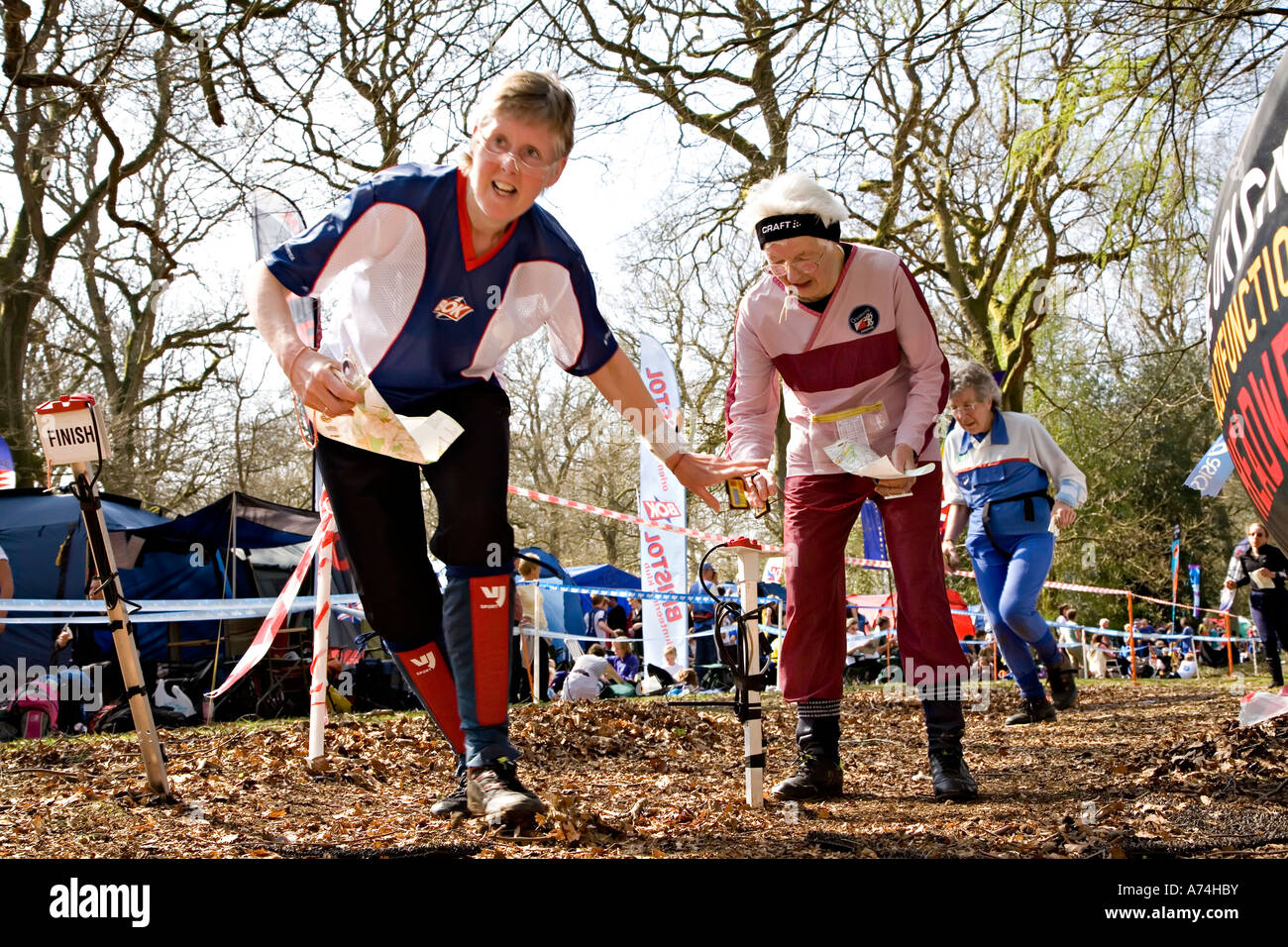 Competitors crossing the finishing line at an orienteering event Forest ...