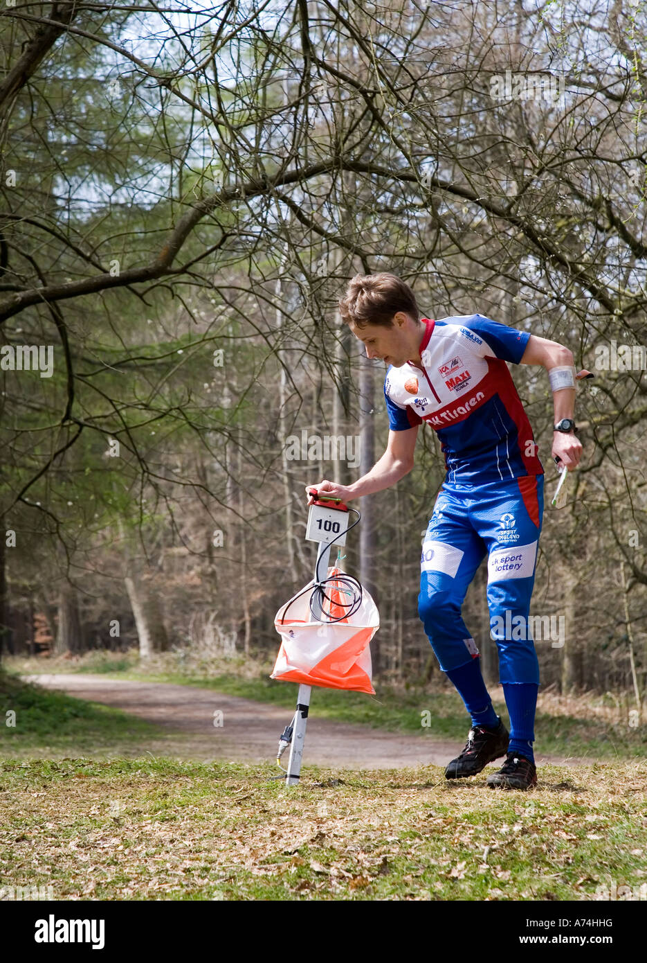 Competitor punching a control point with his e card tag at an ...
