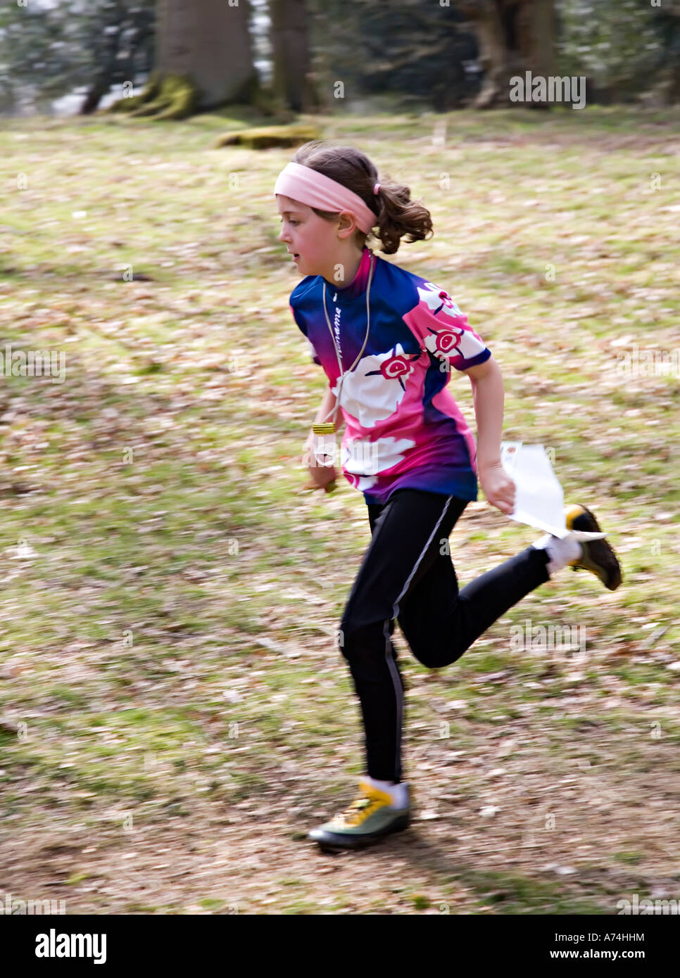 Girl running in forest during orienteering event Forest of Dean UK ...