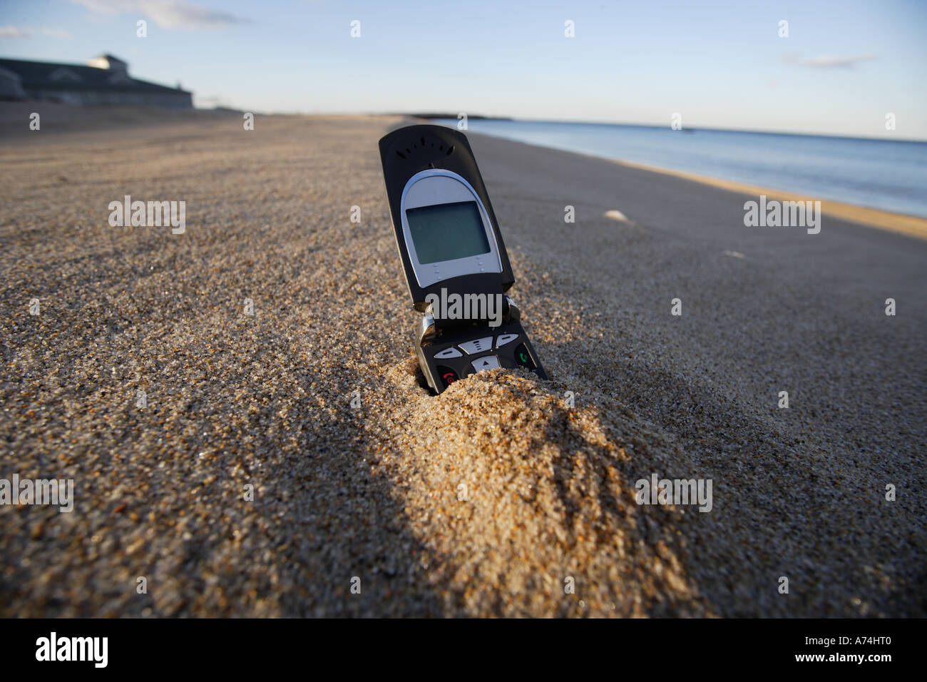 Cell phone in sand on Beach Stock Photo - Alamy