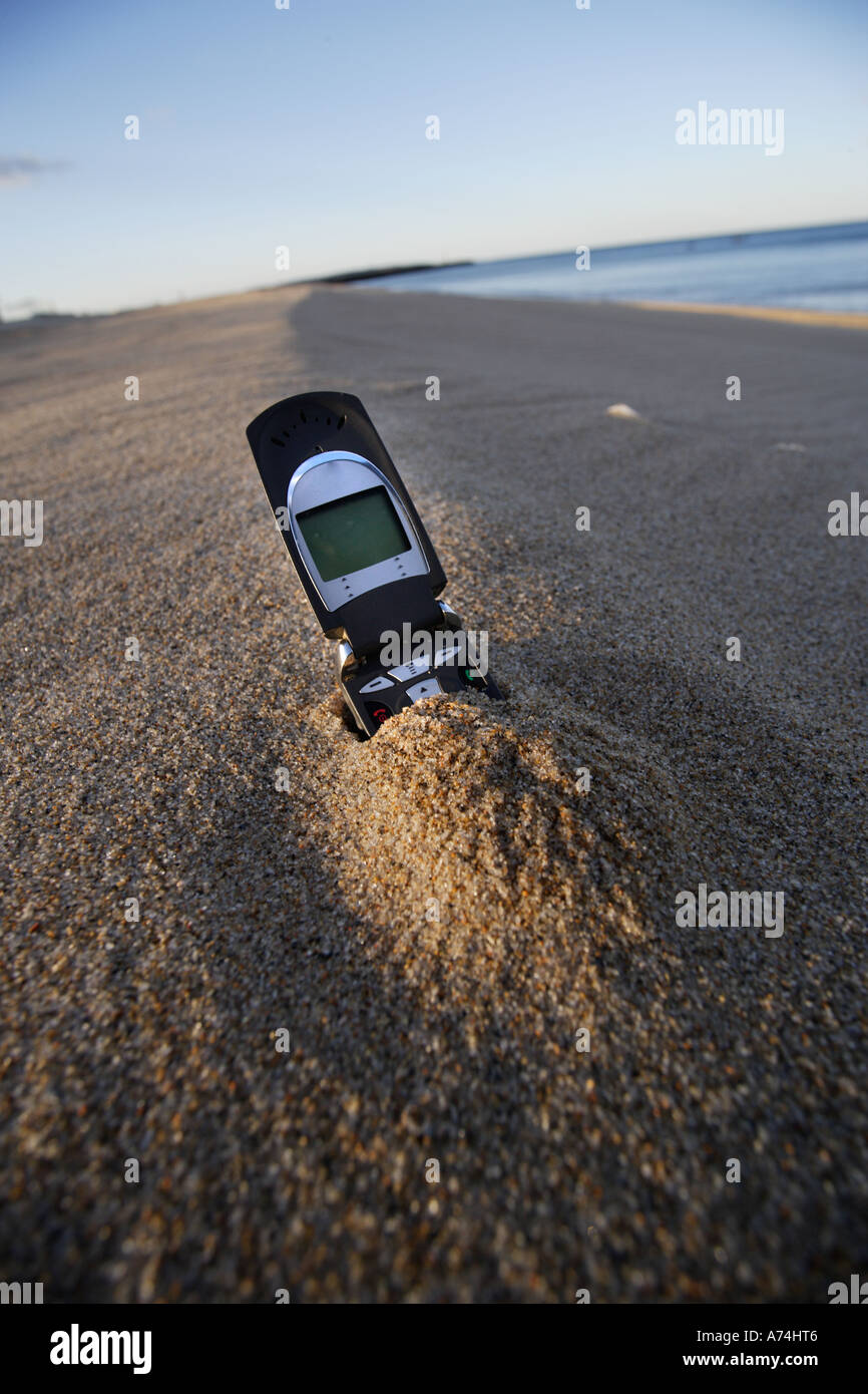 Cell phone in sand on Beach Stock Photo - Alamy