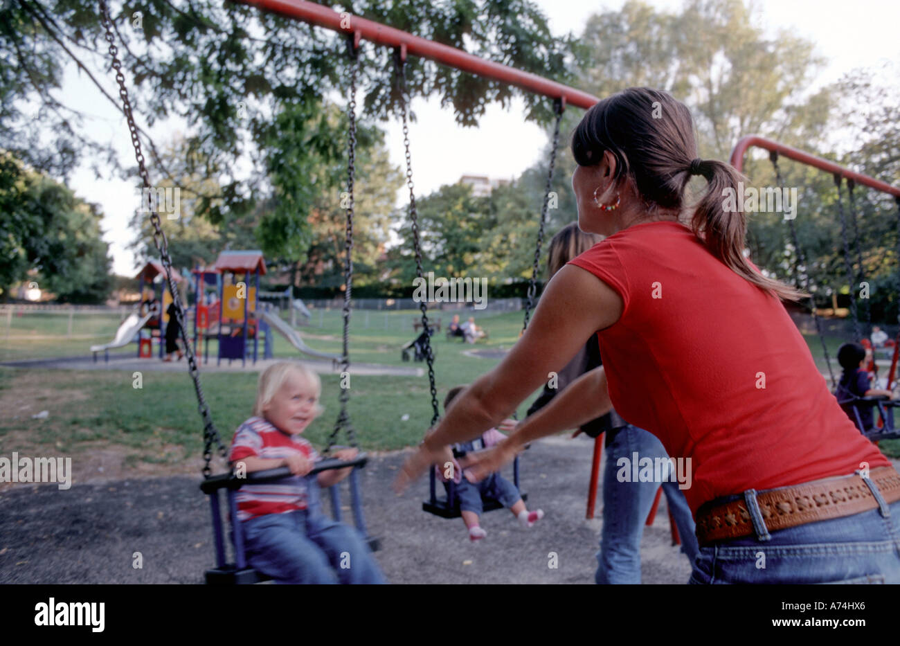Mother pushing child swing hi-res stock photography and images - Alamy