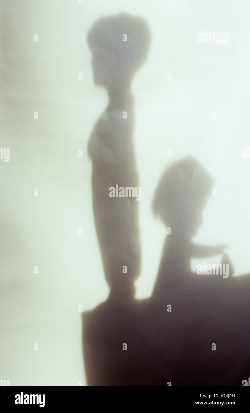 Shadow in warm light on pale cloth or curtain of traditional baby doll ...