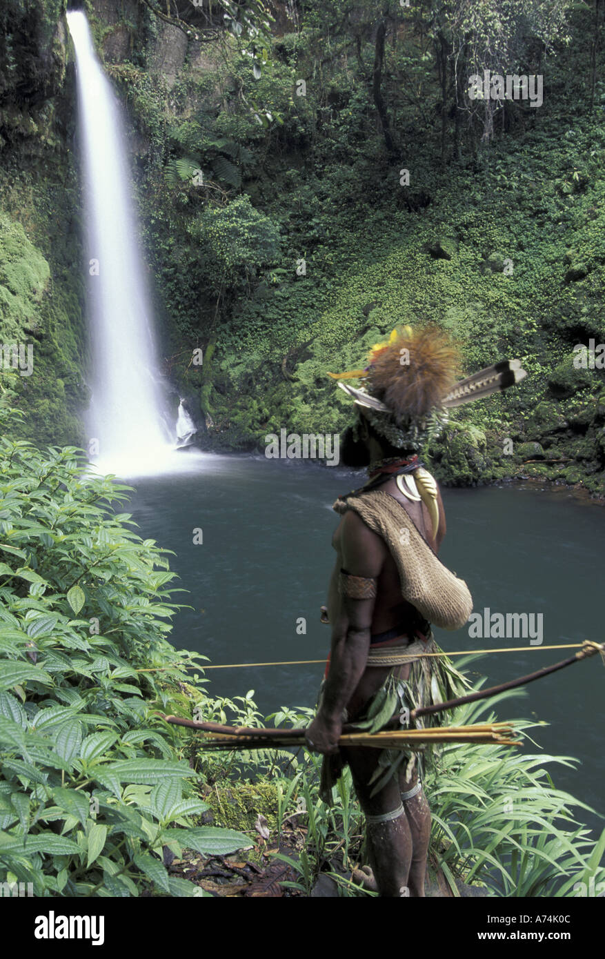Asia, Papua New Guinea, Highland territory. Huli Wigman at Ambua Falls ...