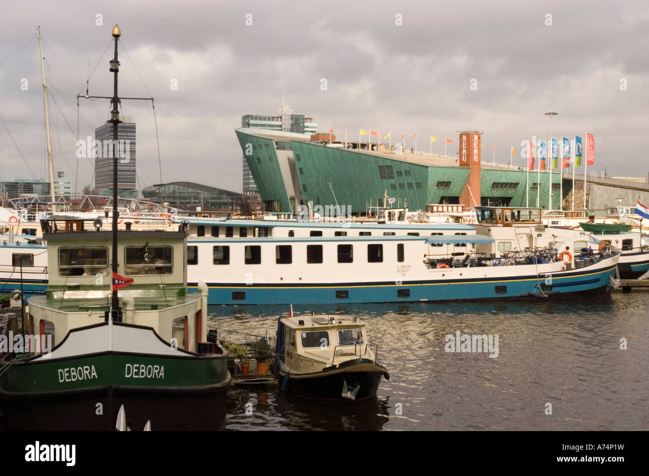 Amsterdam port with ships and green Nemo entertainment centre for ...