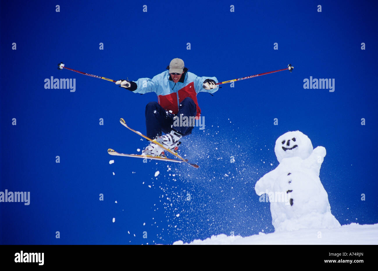 skier jumping with snowman in background Stock Photo - Alamy