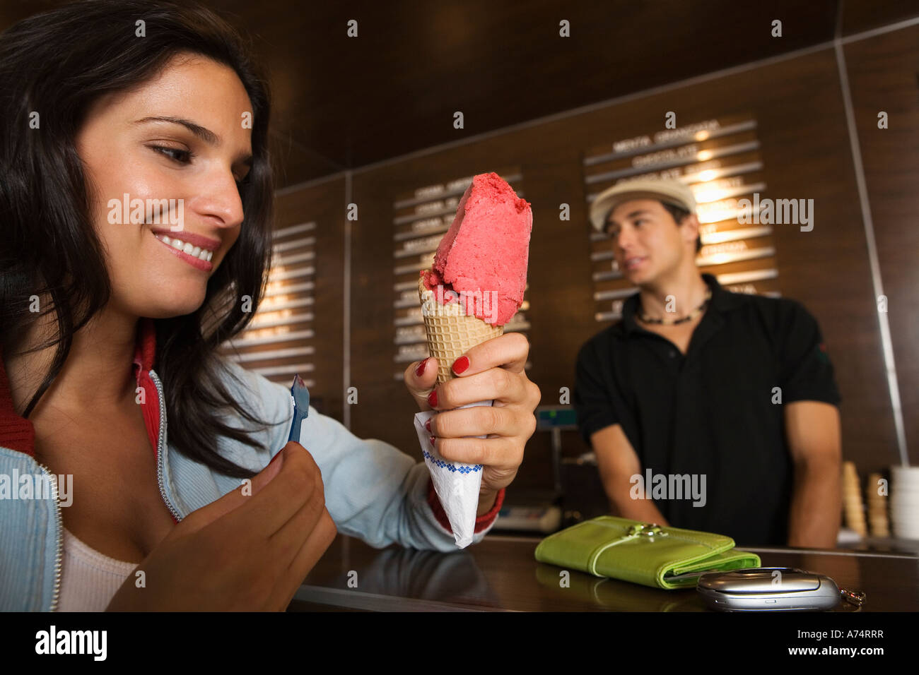 Woman eating ice cream cone with spoon Stock Photo - Alamy