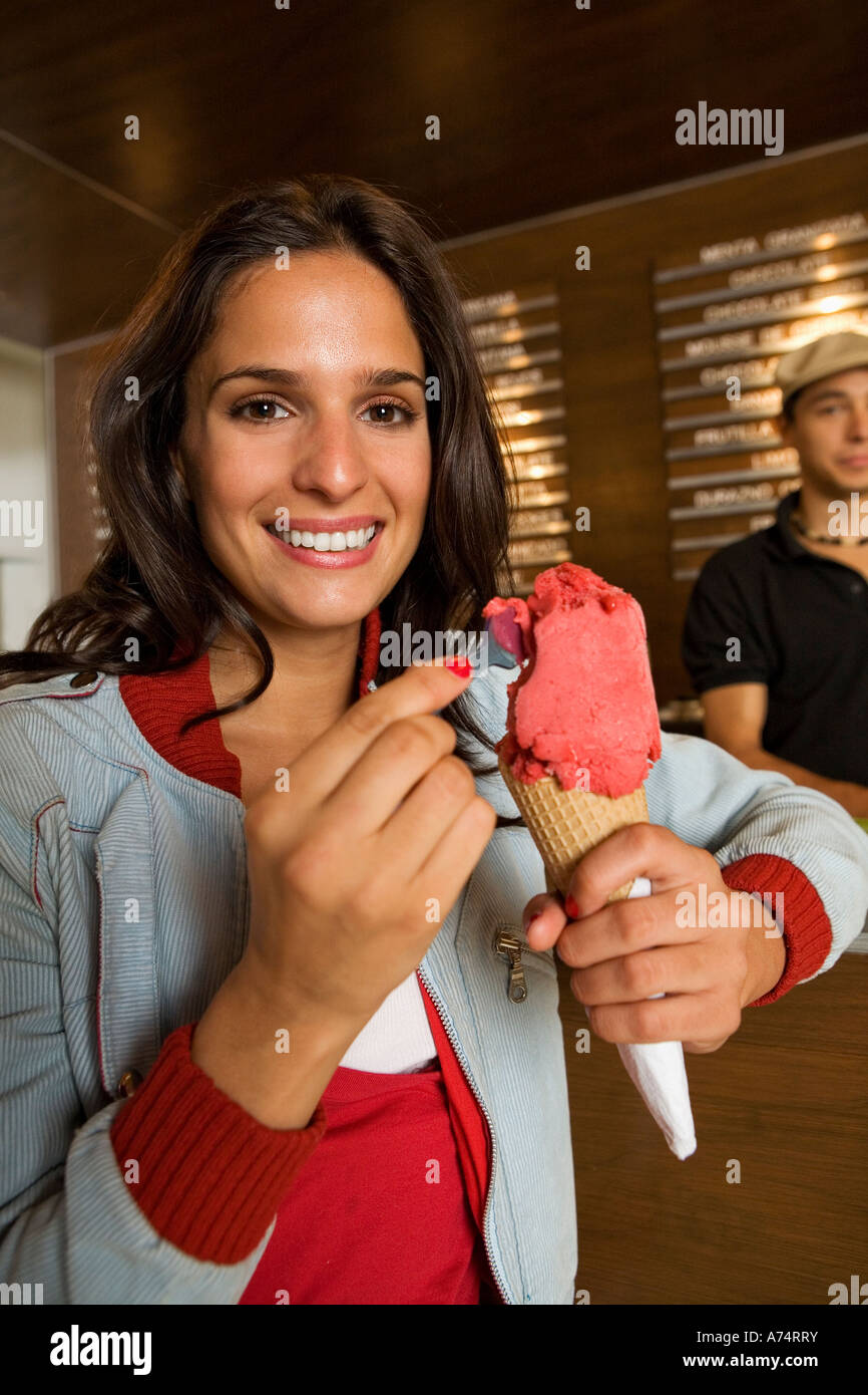 Woman eating ice cream cone with spoon Stock Photo - Alamy