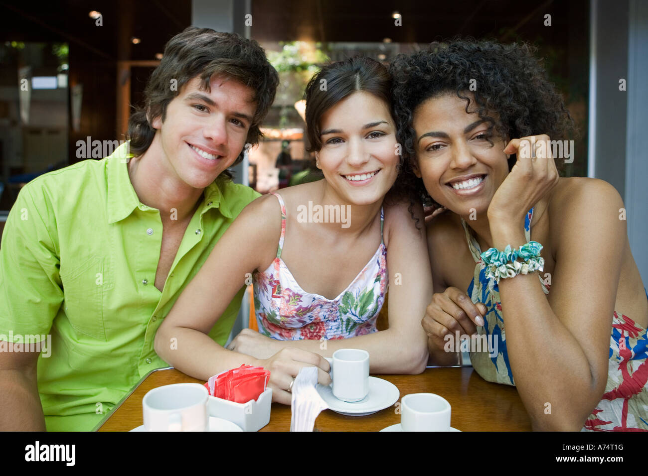Friends smiling at outdoor cafe Stock Photo - Alamy