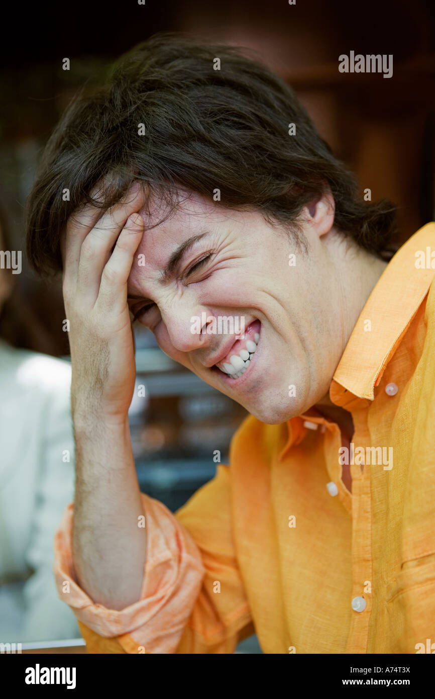 Embarrassed man laughing Stock Photo - Alamy