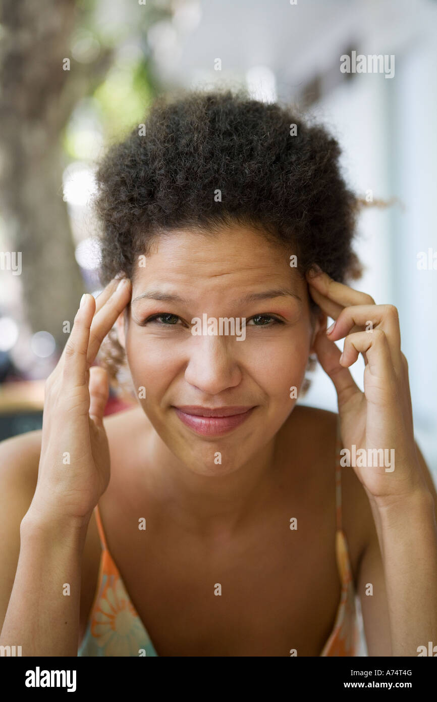 Frustrated woman rubbing her temples Stock Photo - Alamy