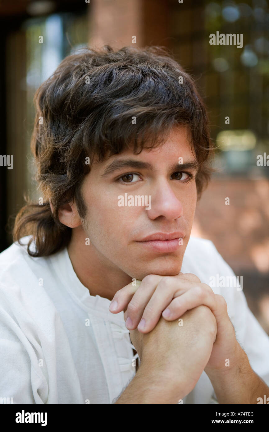 Man resting chin in hands Stock Photo - Alamy