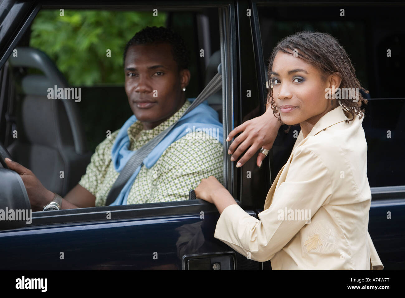 Couple talking through car window Stock Photo - Alamy