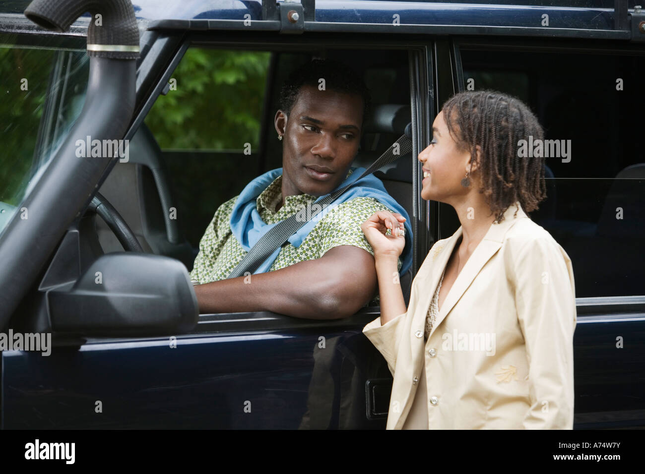 Couple talking through car window Stock Photo - Alamy