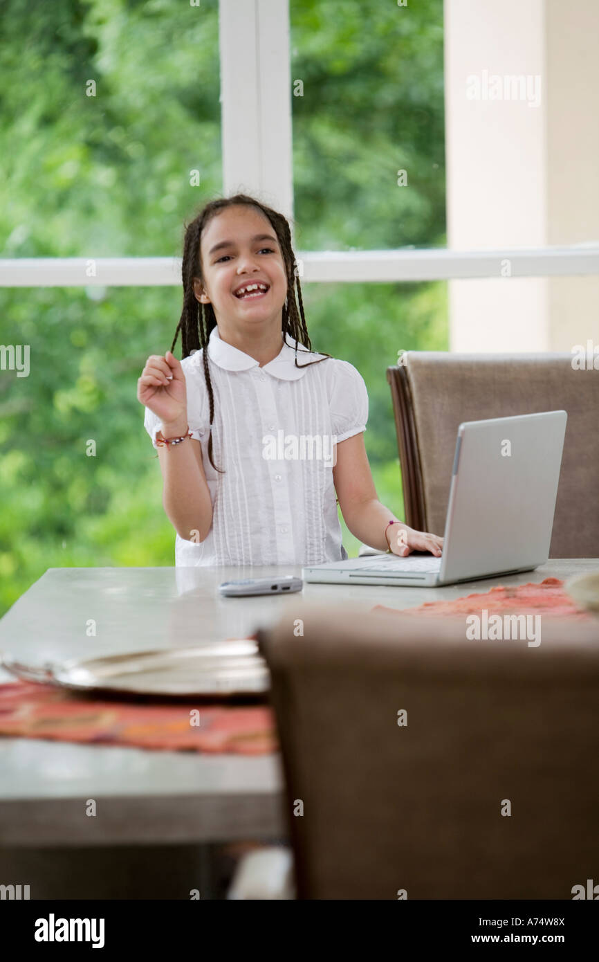 Young girl using laptop Stock Photo - Alamy