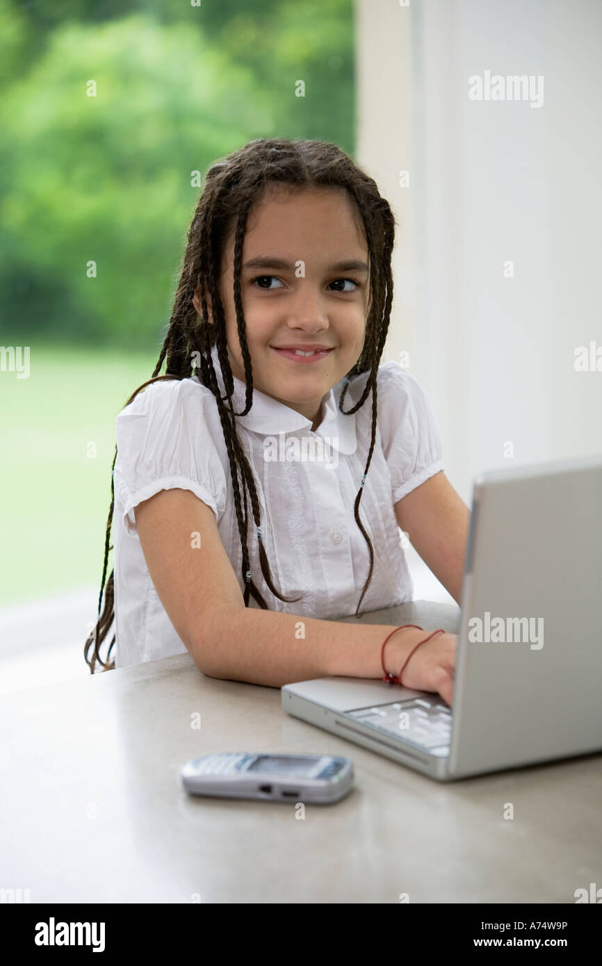 Young girl using laptop Stock Photo - Alamy