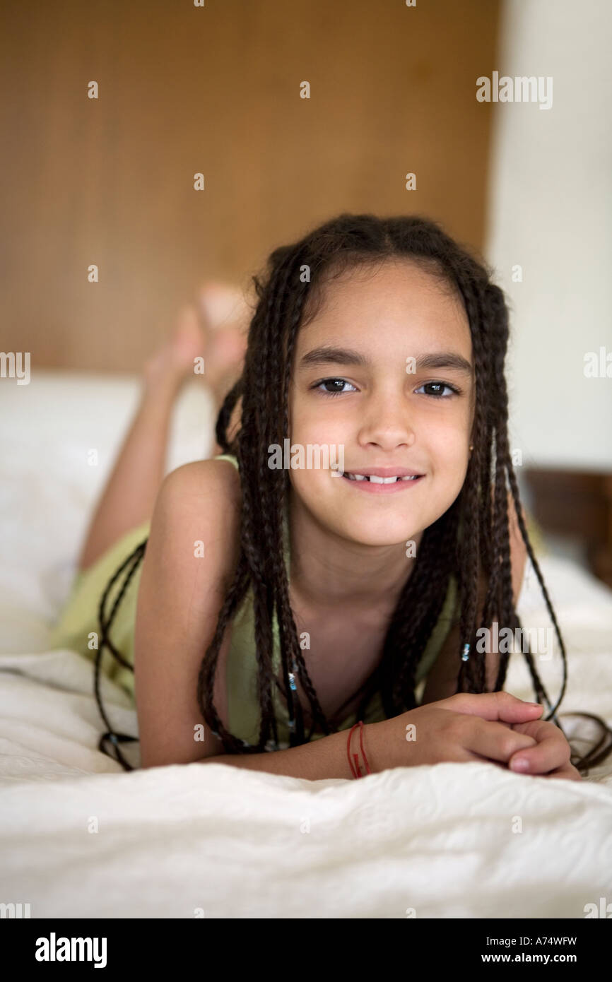 Young girl laying on bed Stock Photo - Alamy
