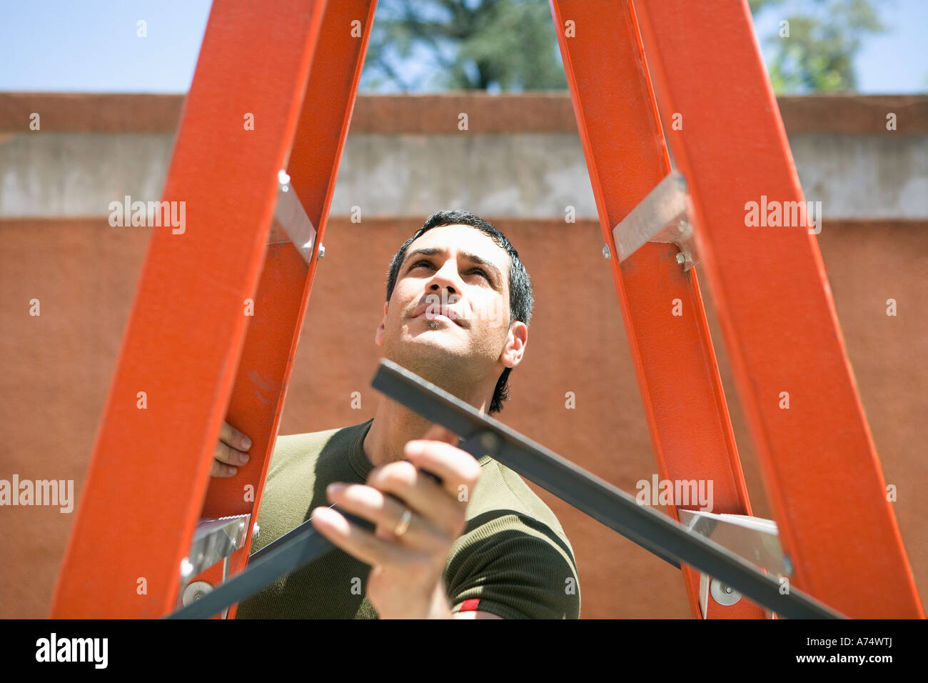 Man collapsing metal ladder Stock Photo - Alamy