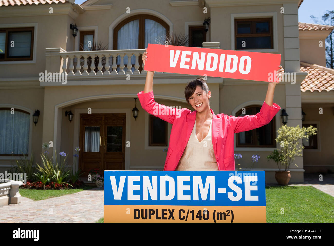 Real estate agent putting “sold” marker on “for sale” sign on open ...