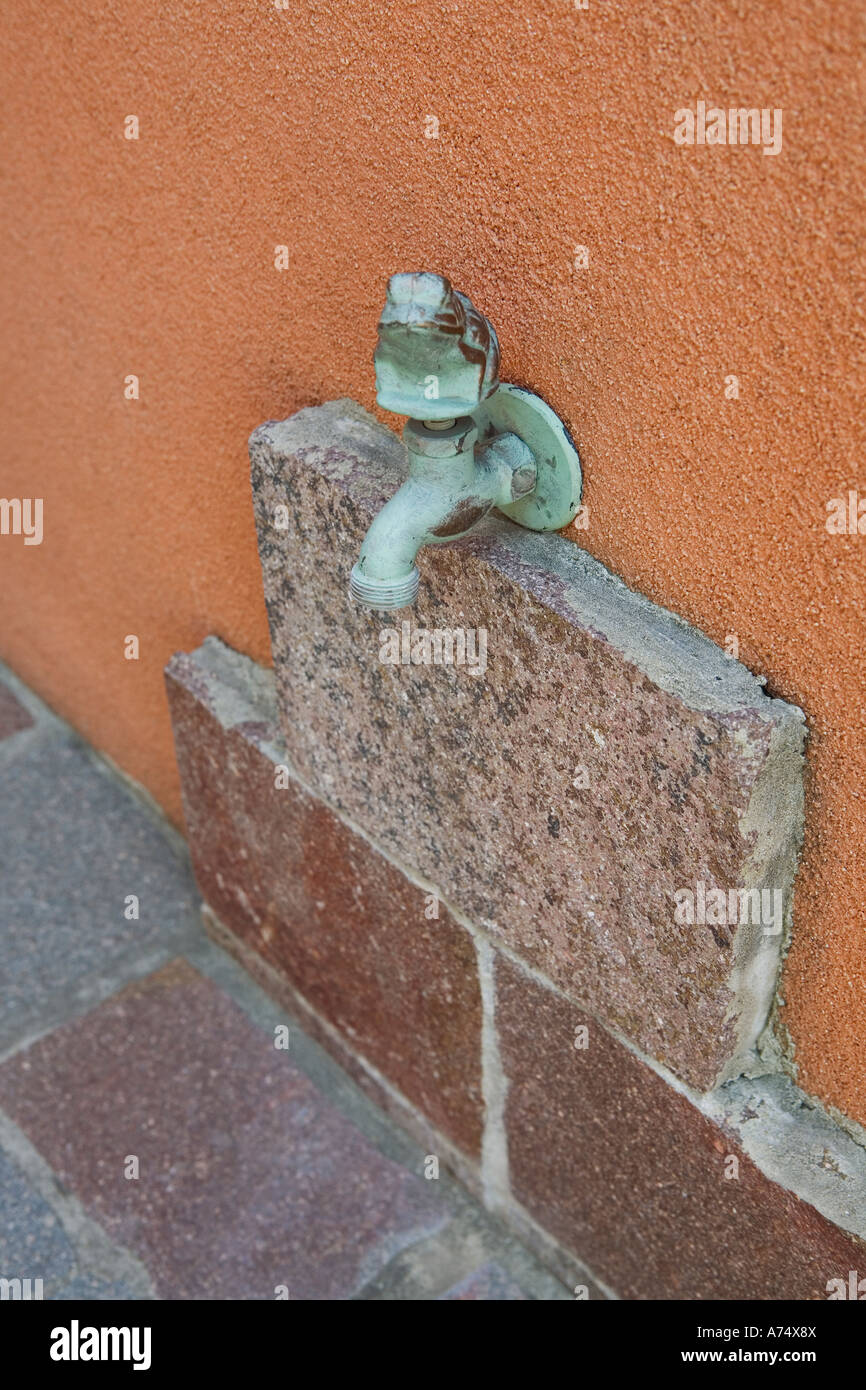 Faucet attached to outside of building Stock Photo - Alamy