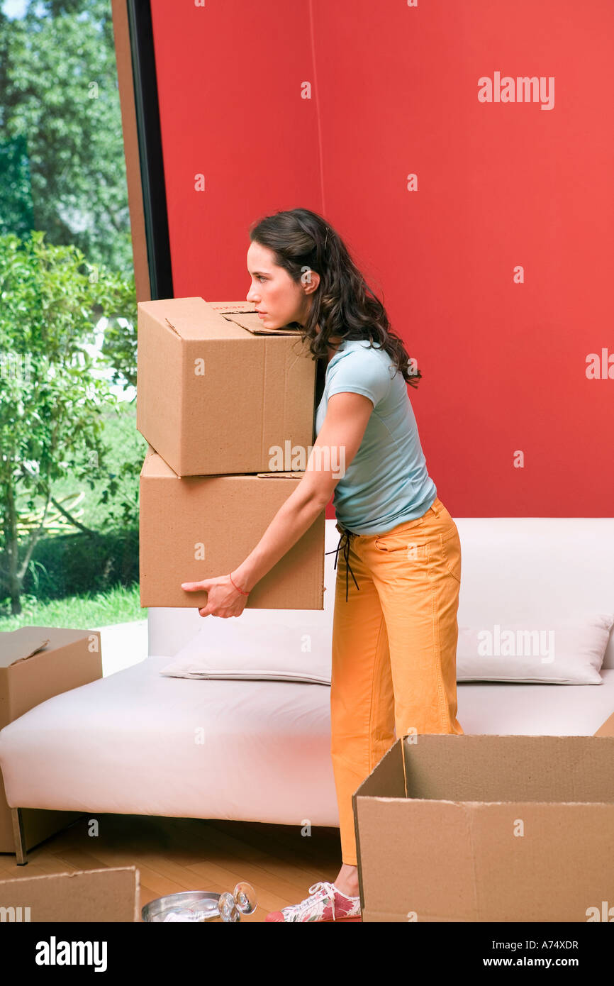 Woman carrying cardboard boxes Stock Photo - Alamy