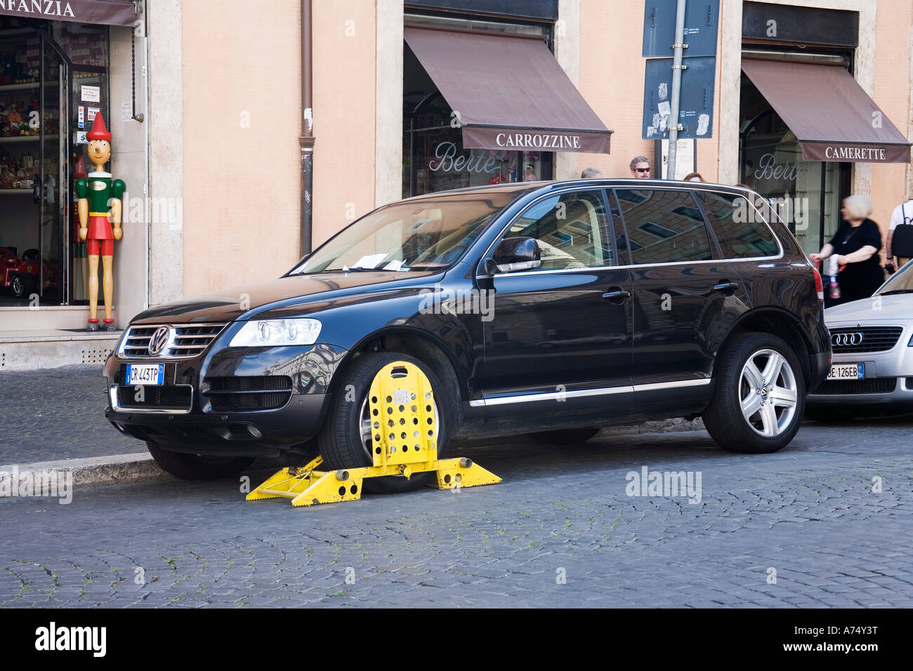 Car with tire boot on for being illegally parked in Rome Italy Stock ...