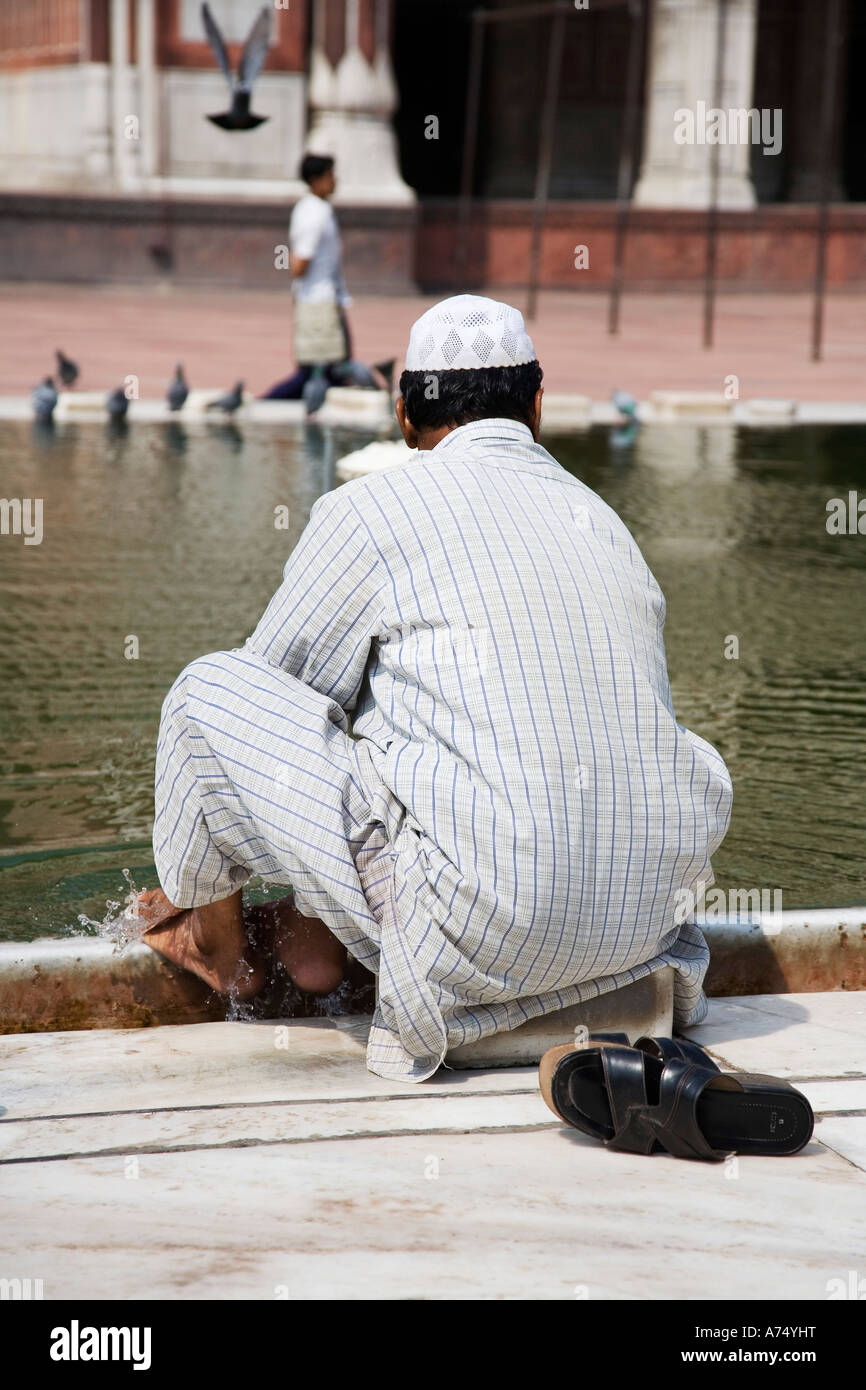 Muslim washing before prayer at the Jami Masjid Mosque in Delhi India ...