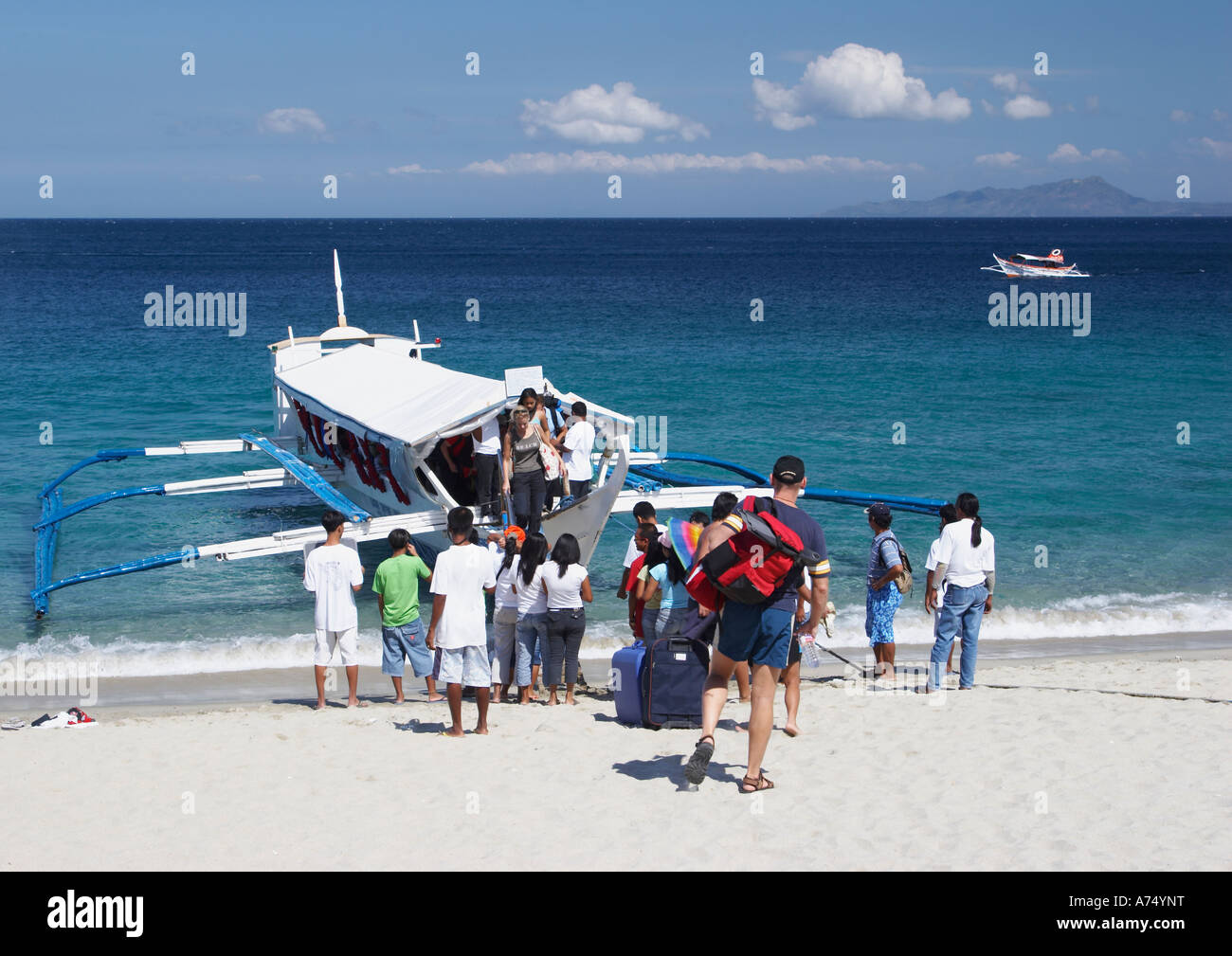 Tourists Arriving At Tropical Beach Stock Photo - Alamy