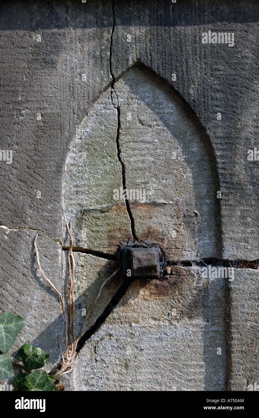 Stone gate hindge showing cracks caused by weathering and rusting of ...