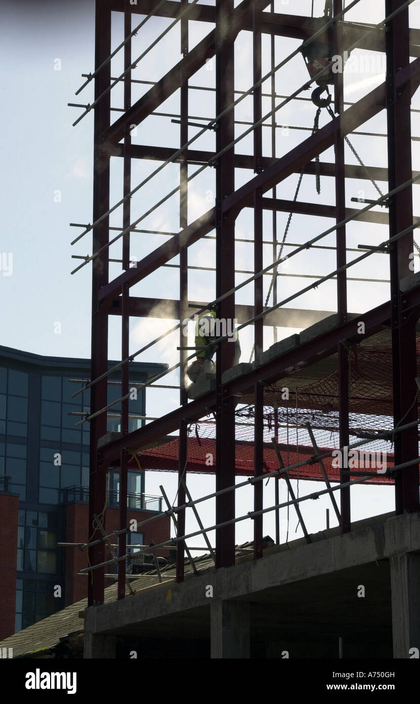 Urban construction worker on steel framed building working on an inner ...