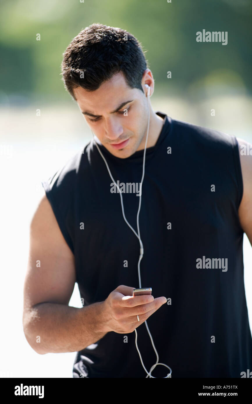Man listening to his mp3 player while jogging Stock Photo - Alamy
