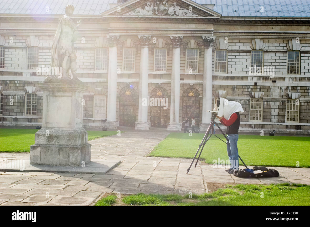 Photographer using a large format camera to photograph a statue in the ...