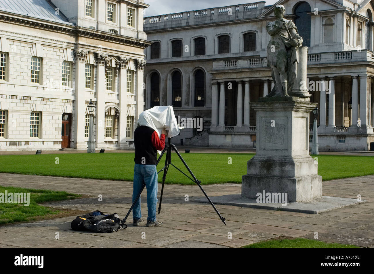 Photographer using a large format camera to photograph a statue in the ...