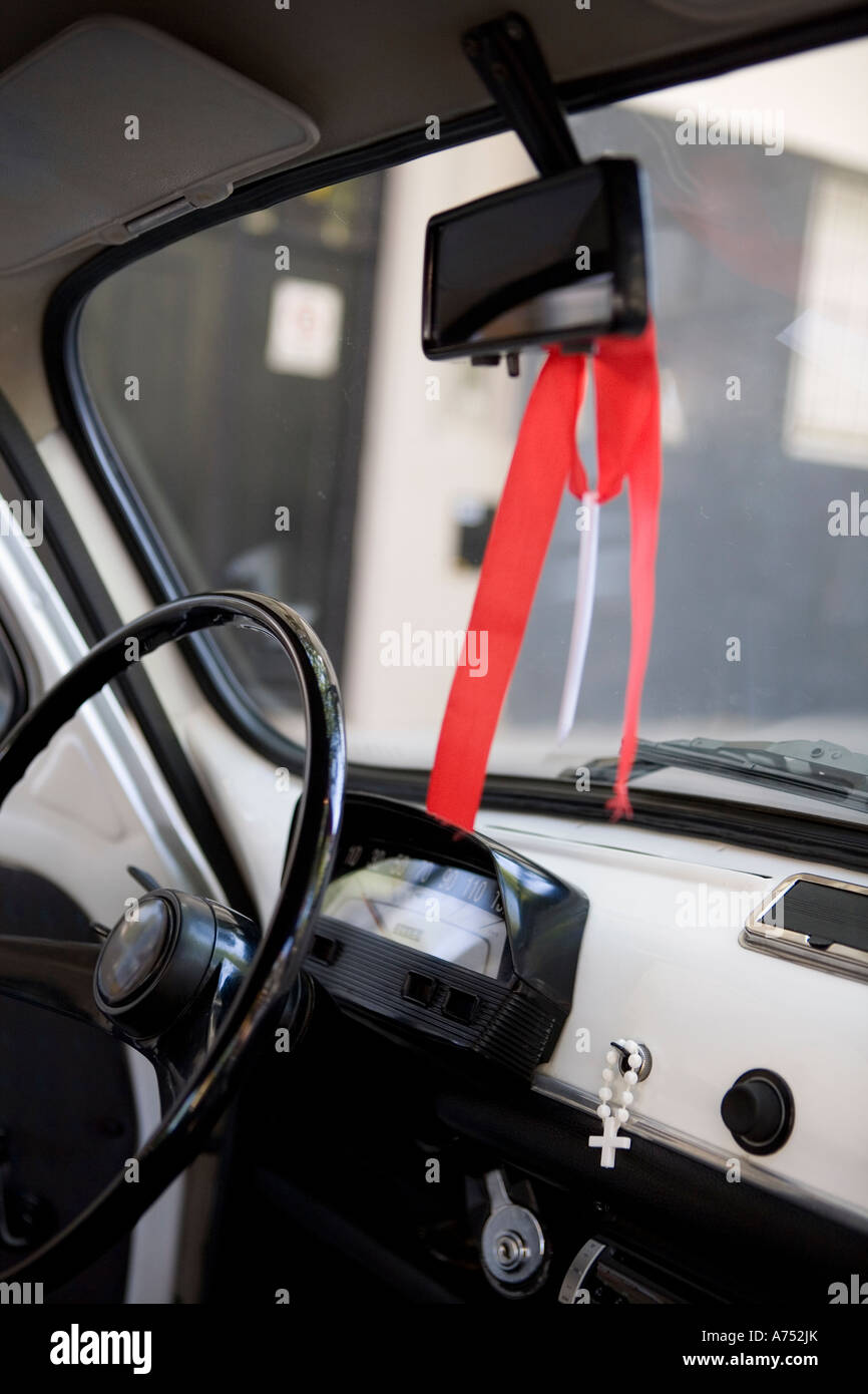 Red ribbon dangling from rear view mirror Stock Photo - Alamy