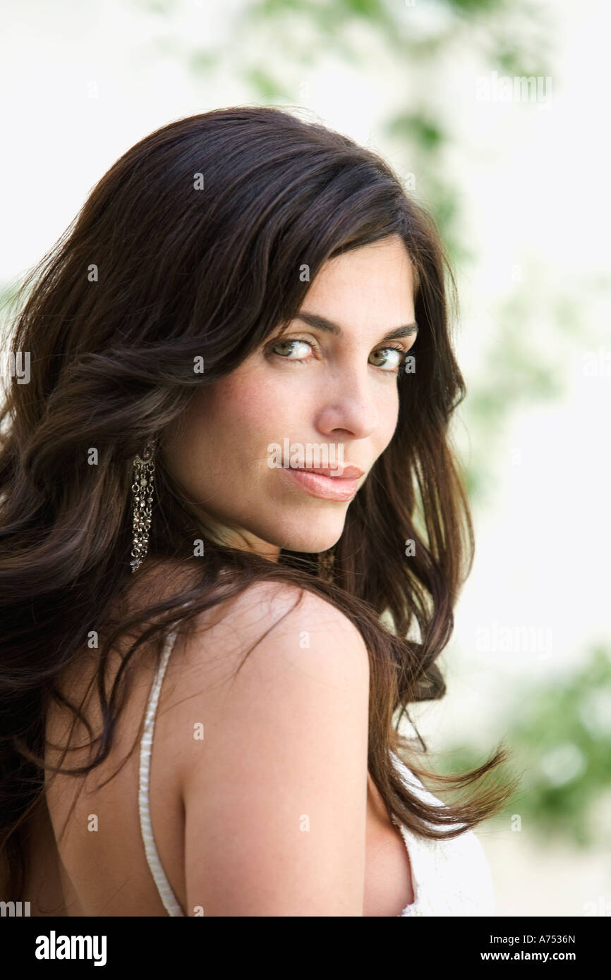 Woman looking over her shoulder Stock Photo - Alamy