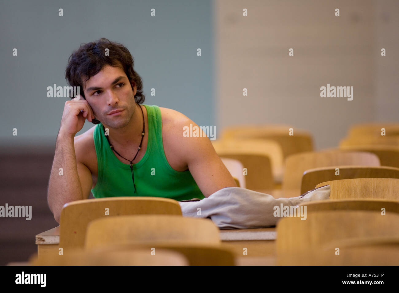 Man studying in empty classroom Stock Photo - Alamy