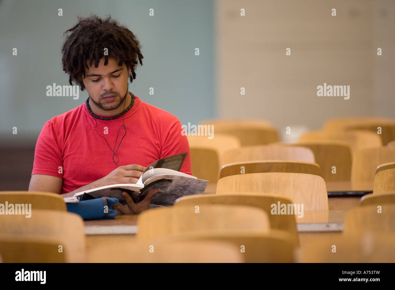 Man studying in empty classroom Stock Photo - Alamy