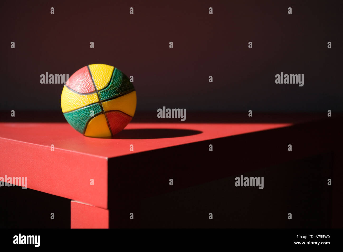 Rubber ball on red table with black shadow abstract Stock Photo - Alamy
