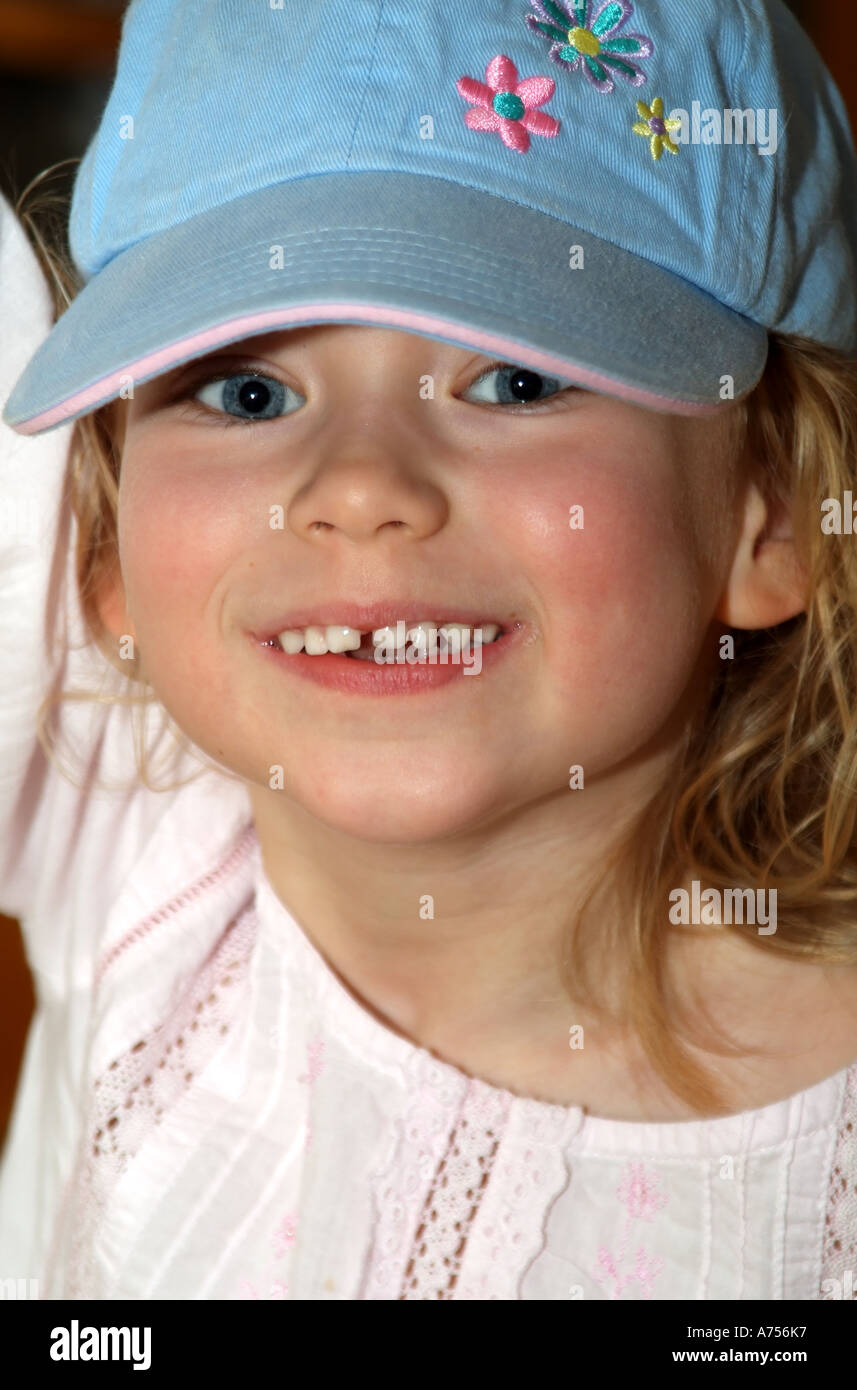 Little attractive girl wearing a baseball cap play acting a cool dude ...