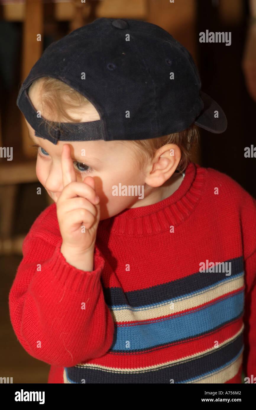 Little boy wearing a baseball cap play acting a cool dude Stock Photo ...