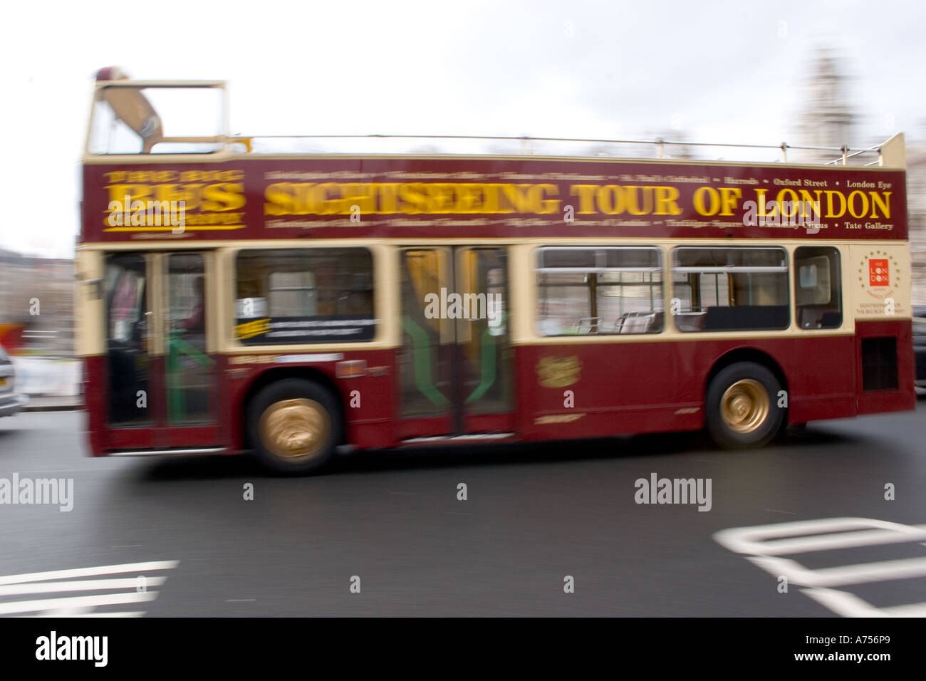 An open top sightseeing bus travels past at great speed Stock Photo - Alamy