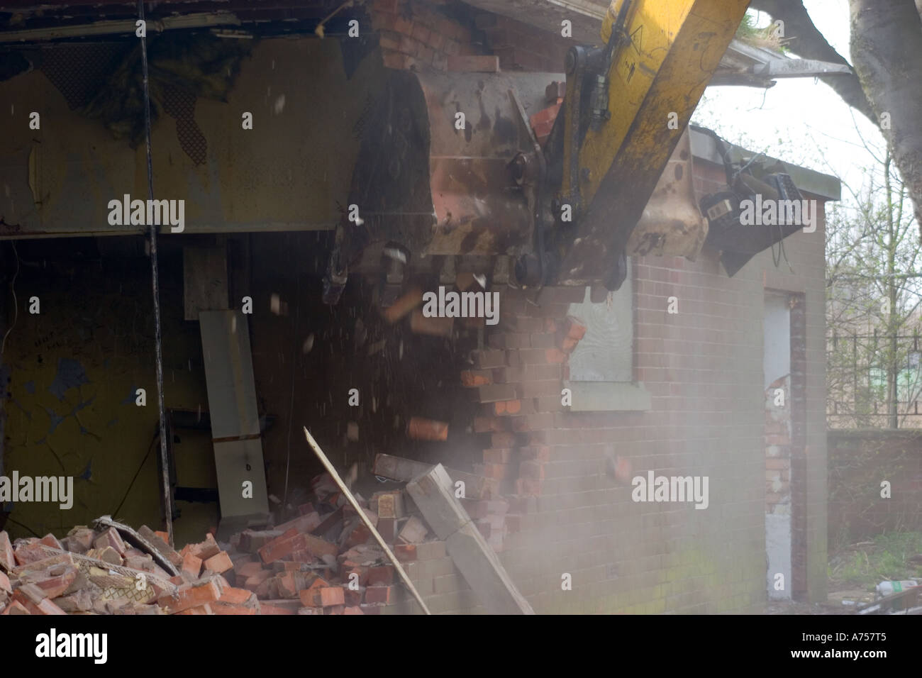 An old derelict building being demolished by a digger Stock Photo - Alamy
